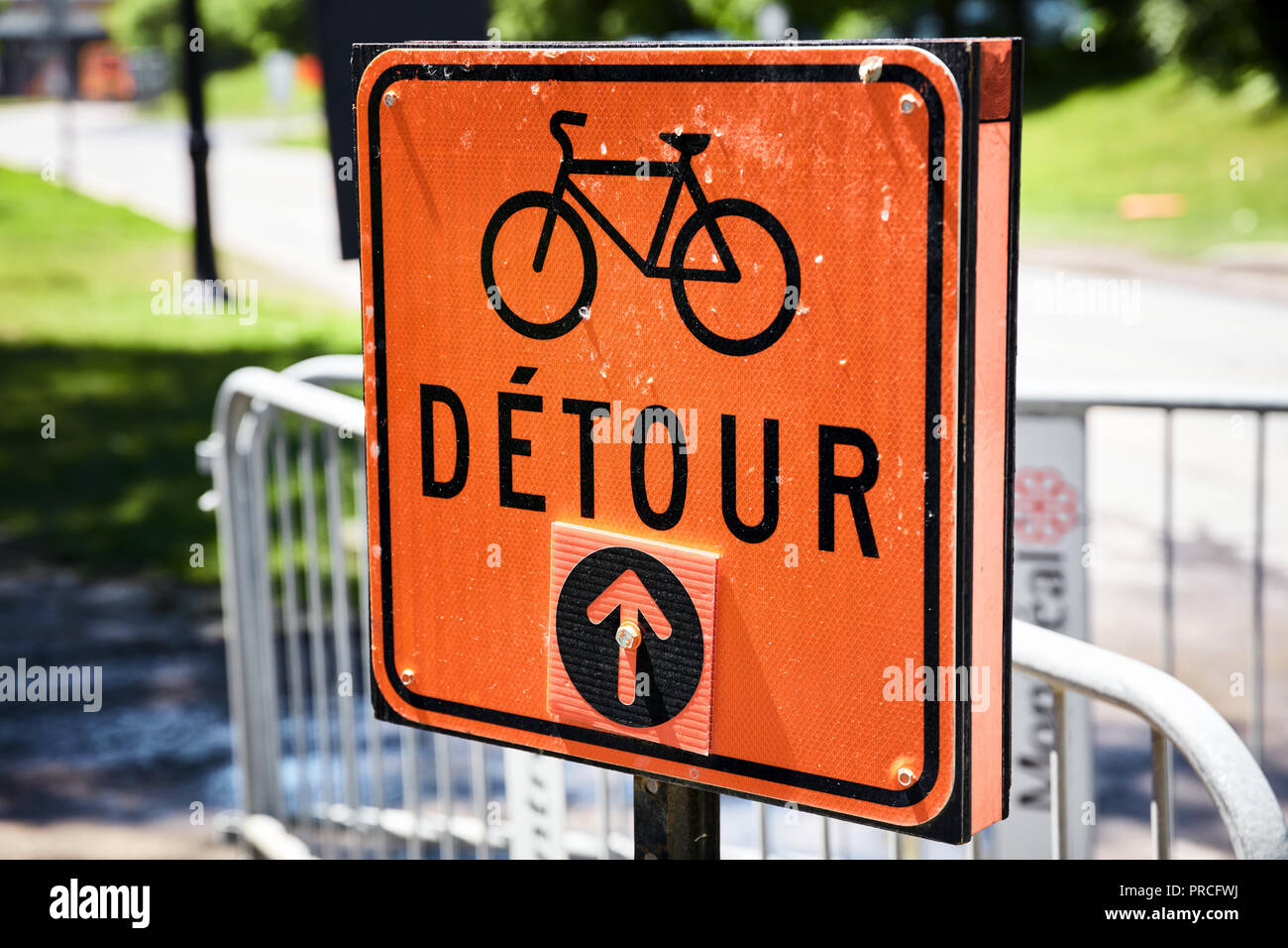 Orange road detour sign for bicycle in French. Arrow pointing straight ...