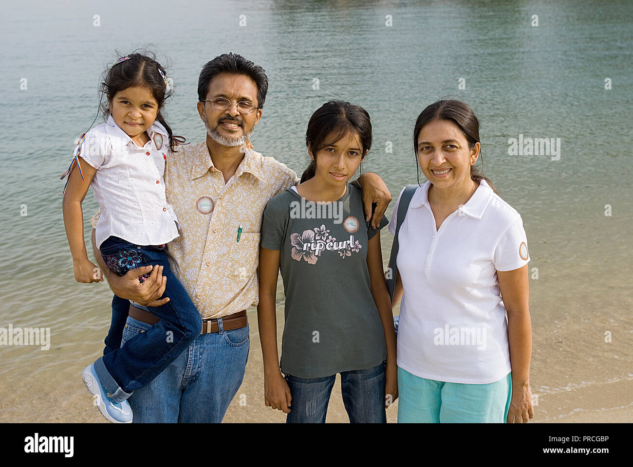 FAMILY OF FOUR ON HOLIDAY ON THE BEACH AT SENTOSA ISLAND, SINGAPORE ...