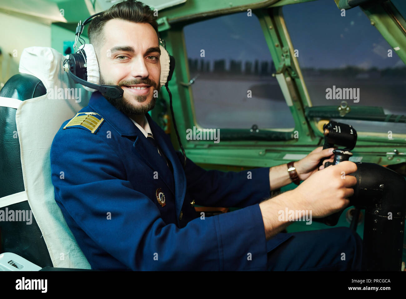 Smiling Pilot in Airplane Stock Photo - Alamy