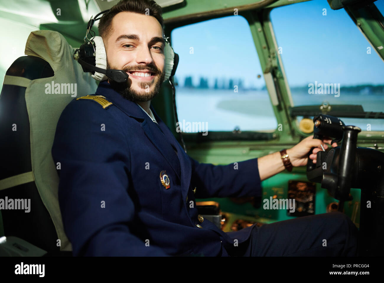 Pilot Posing in Plane Cabin Stock Photo - Alamy