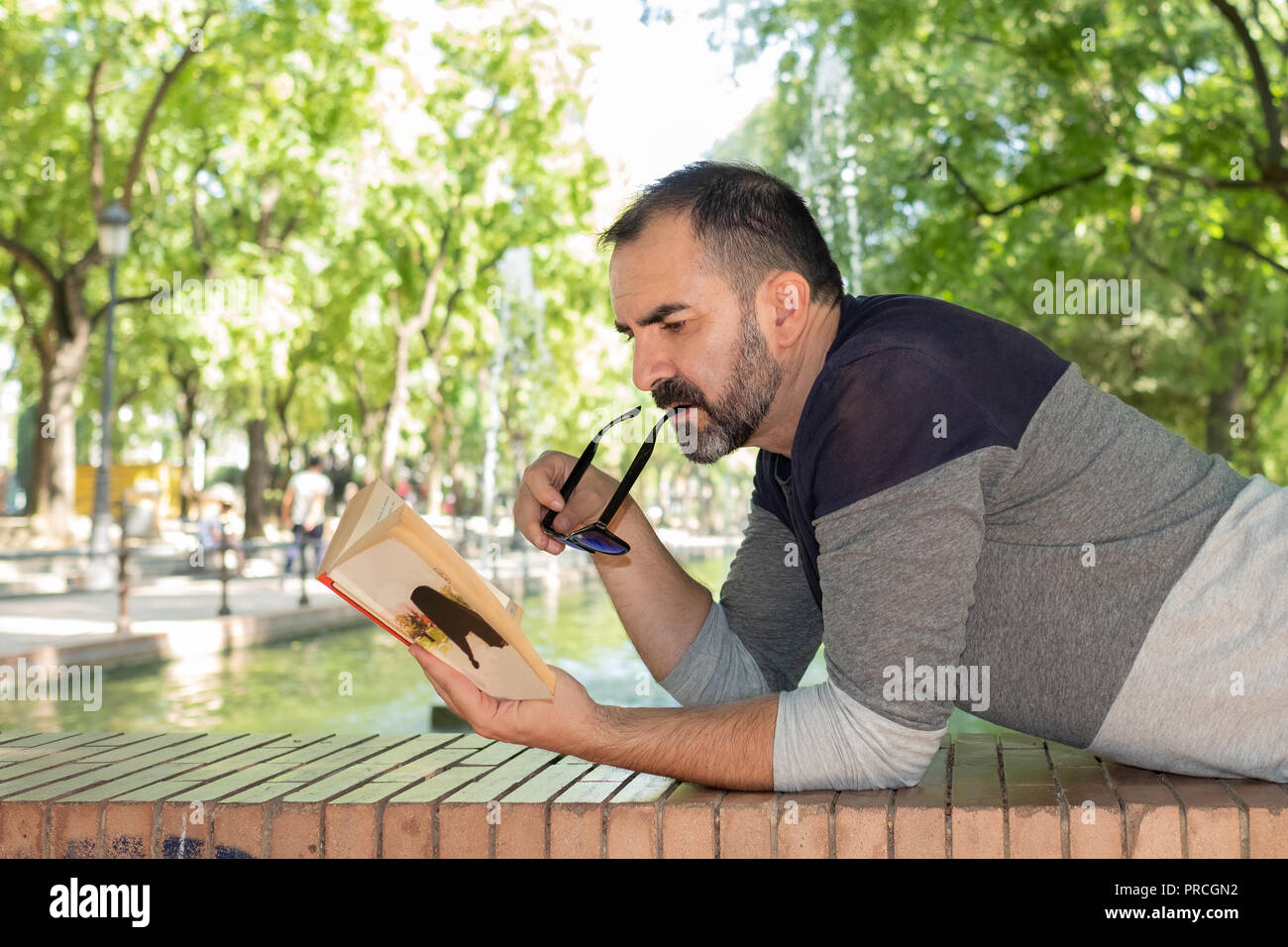 Boy reading a book lying down hi-res stock photography and images - Alamy