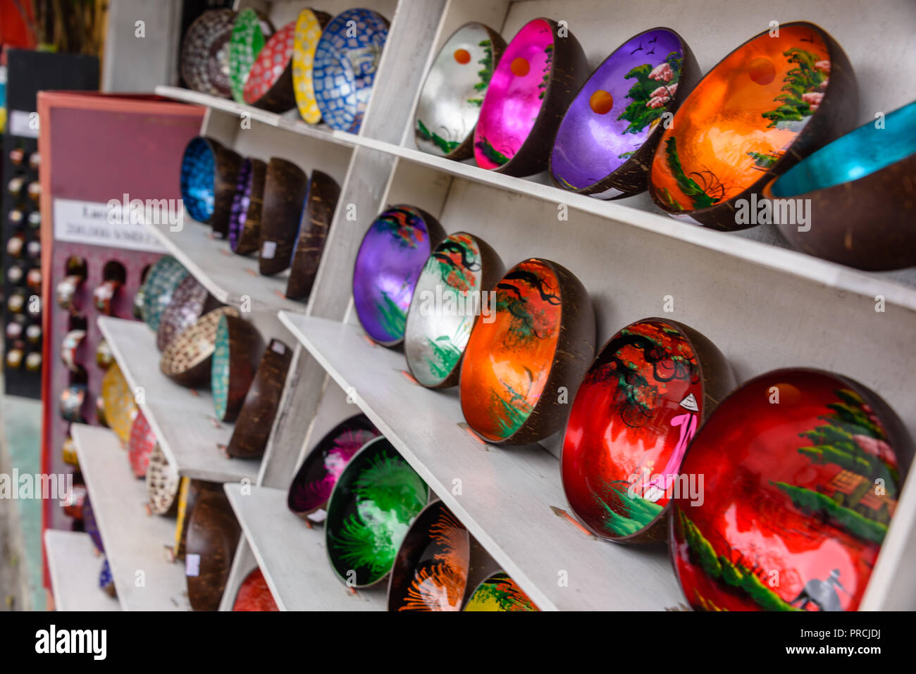 Decorated bowls made from coconut shells on sale at a souvenir shop ...