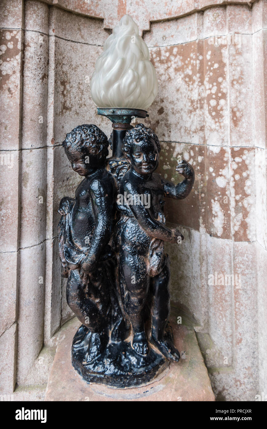 Cast Iron light fitting featuring three cherubs Stock Photo - Alamy