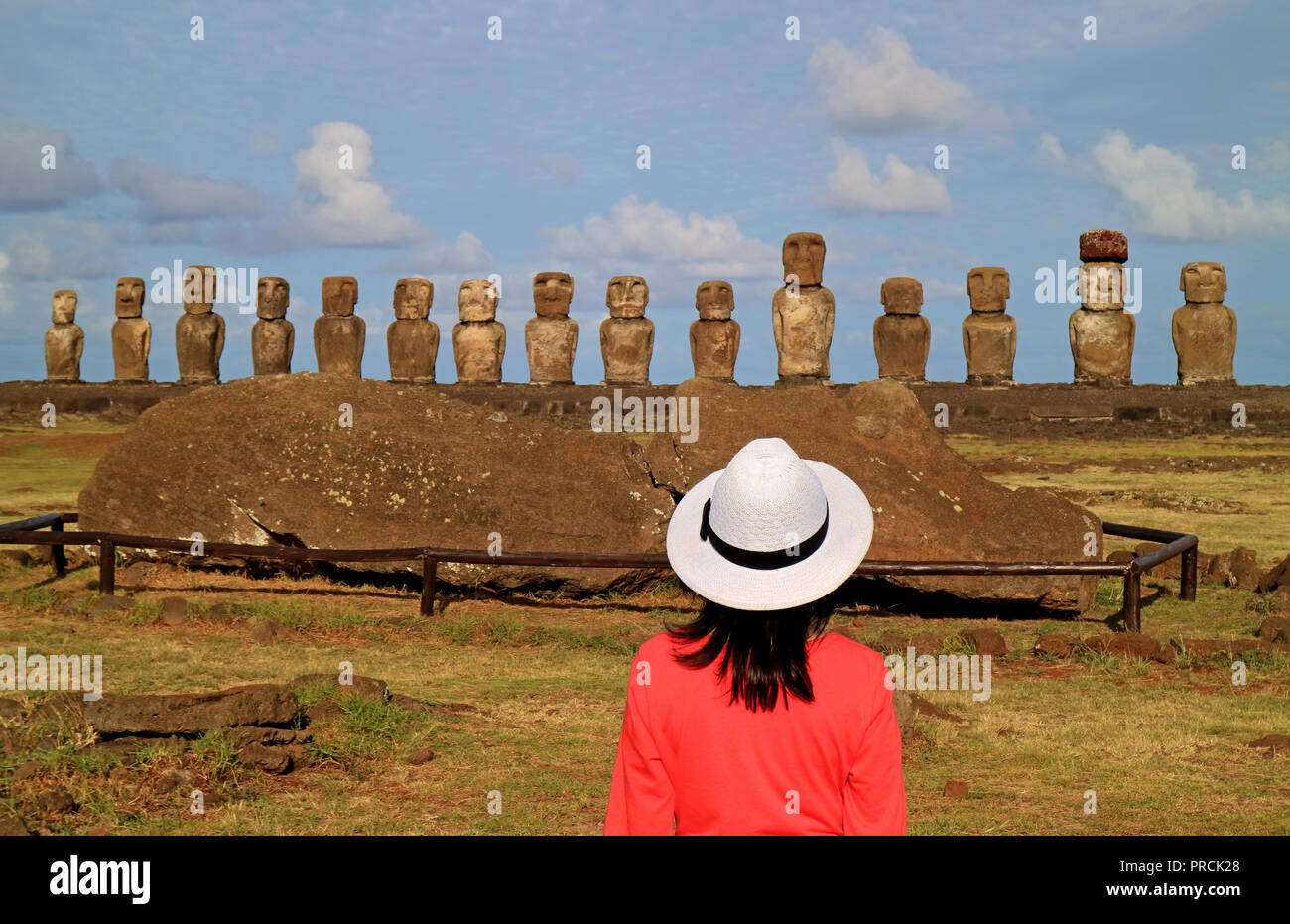 Female tourist impressed by the ruins of Moai statues at Ahu Tongariki ...