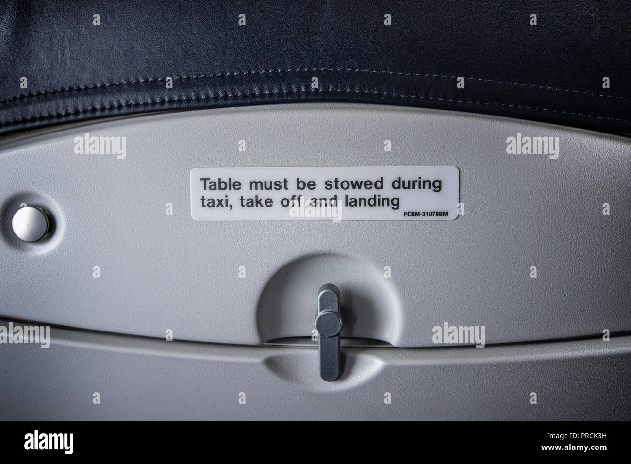 Airplane passenger table usage sign indicating table use during landing ...