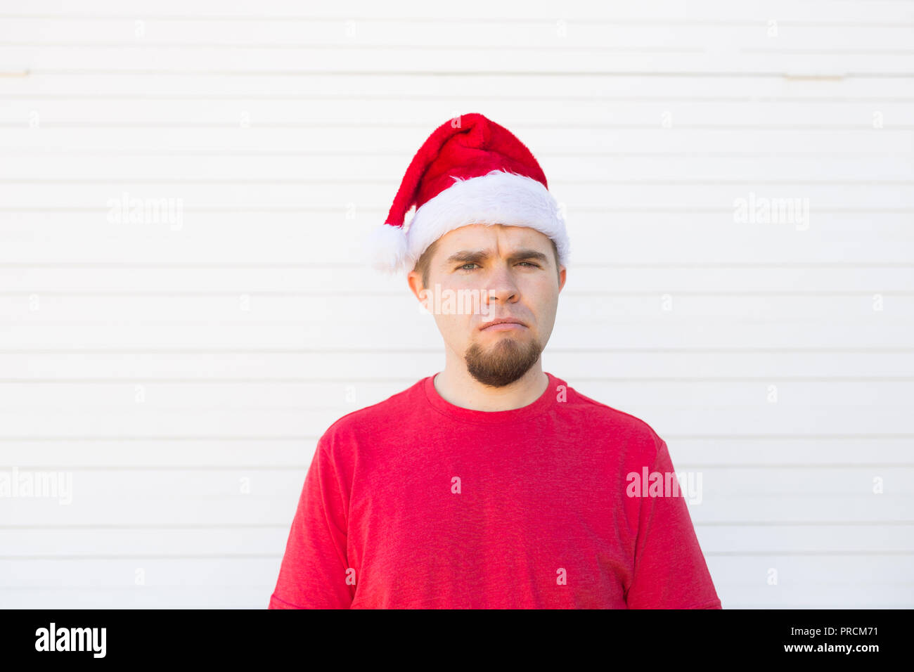 Christmas, people, emotions concept - angry santa in christmas hat ...