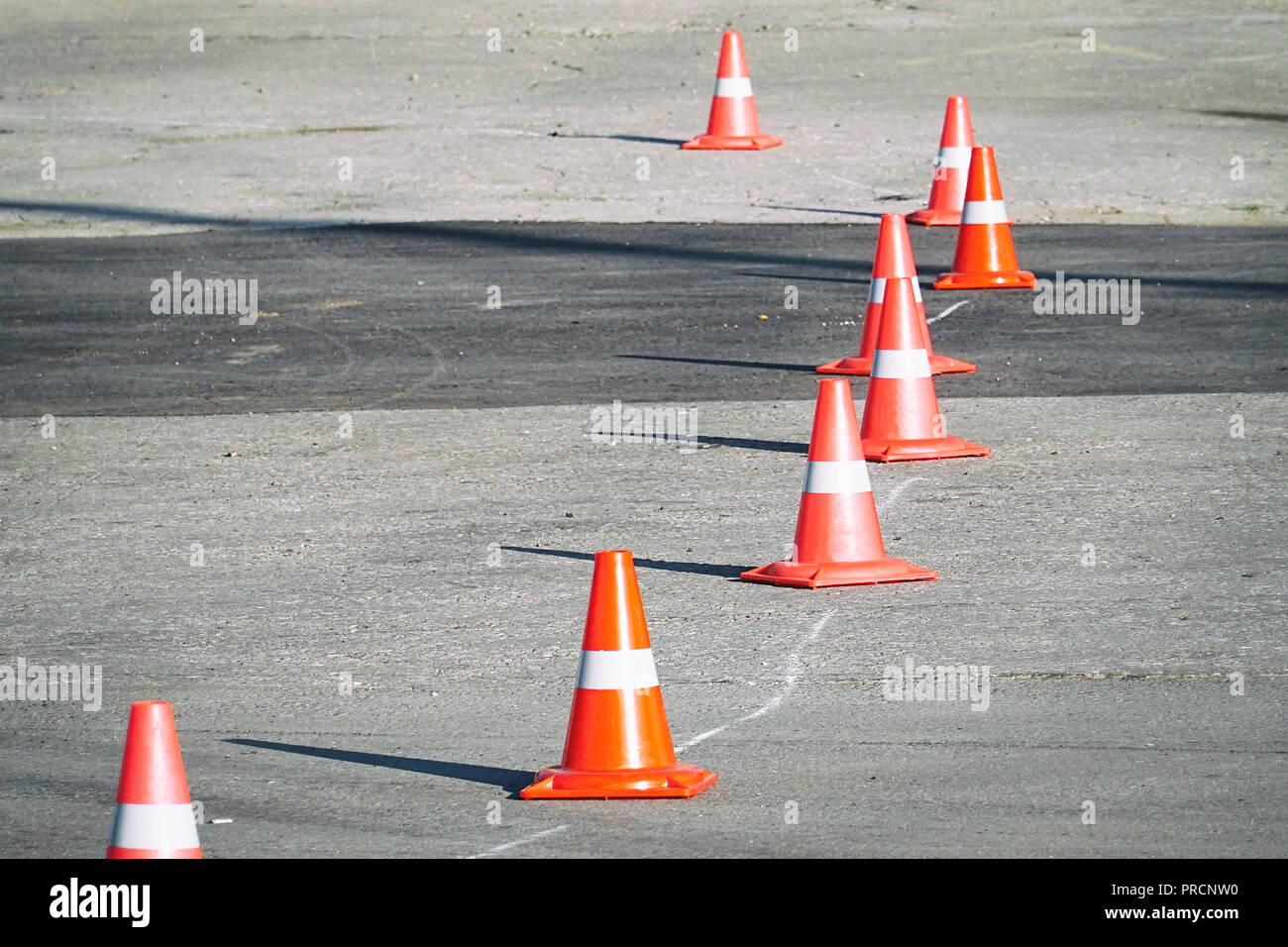 Traffic cone tipped over on pavement Stock Photo - Alamy