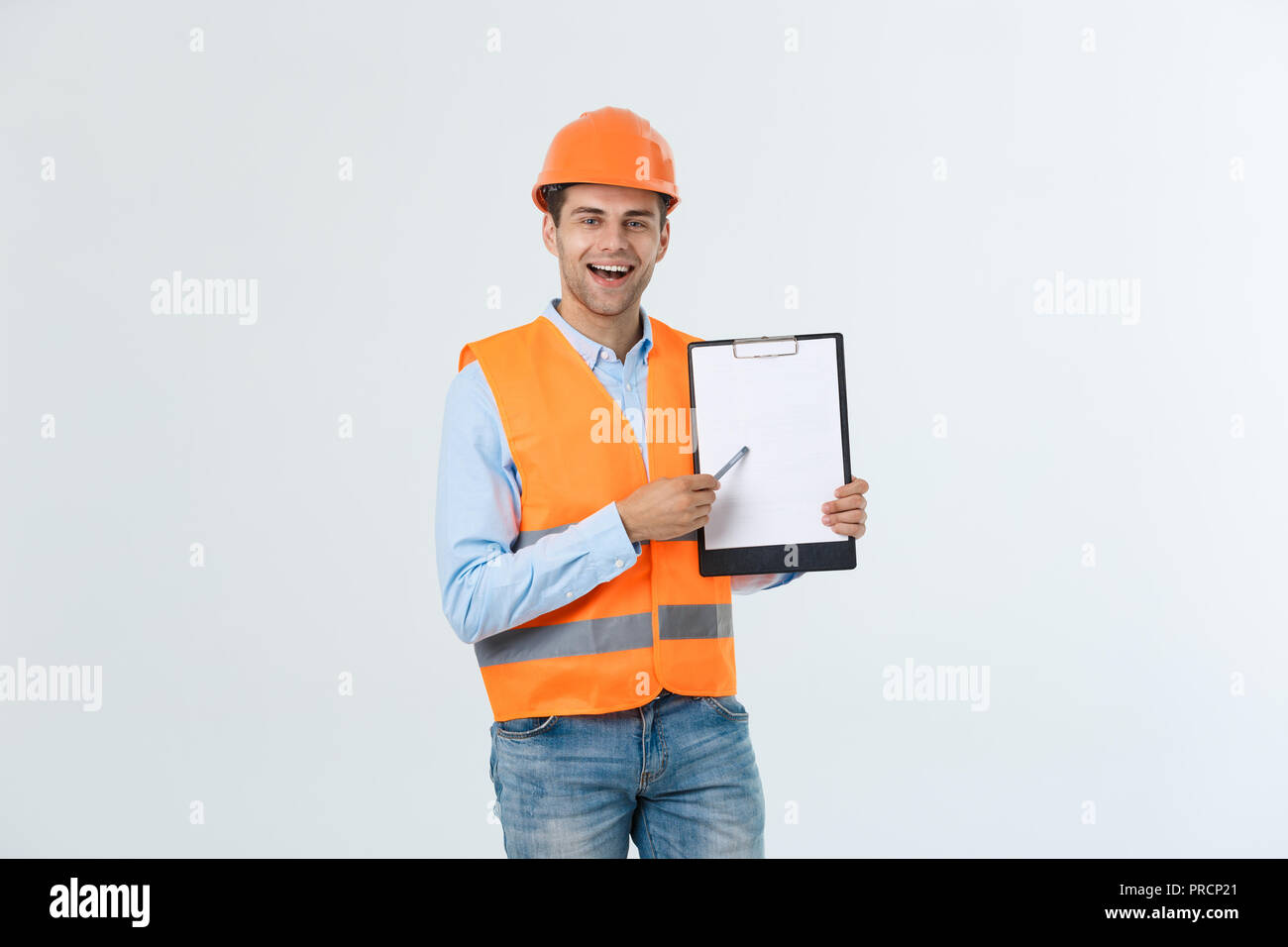 Engineers examining documents on clipboard isolated over white ...