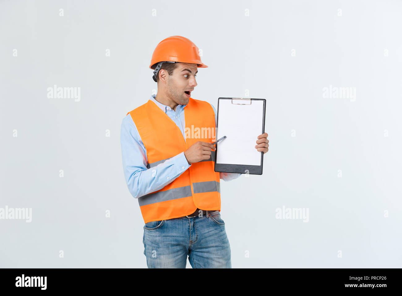 Engineers examining documents on clipboard isolated over white ...
