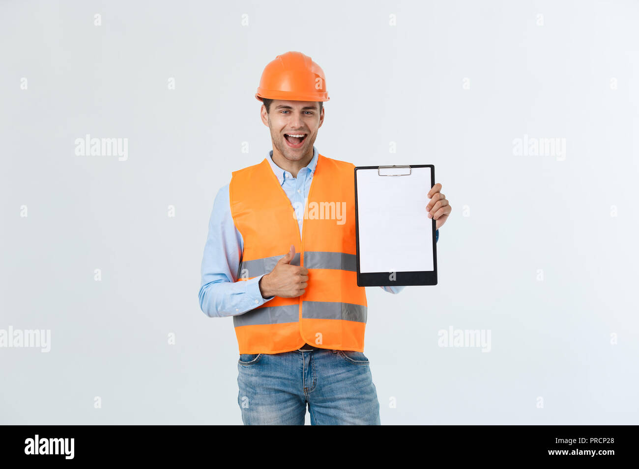 Engineers examining documents on clipboard isolated over white ...