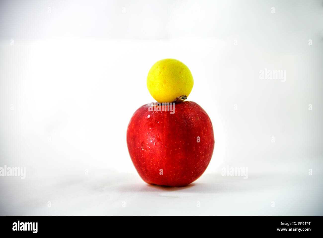 Red apple and yellow lemon isolated in white background Stock Photo - Alamy