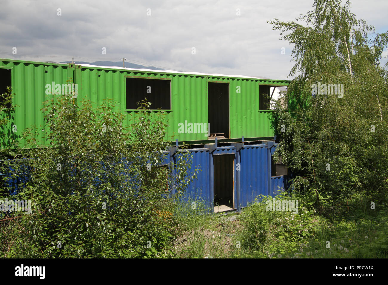 A blue and green containers in storage with the door and window ...