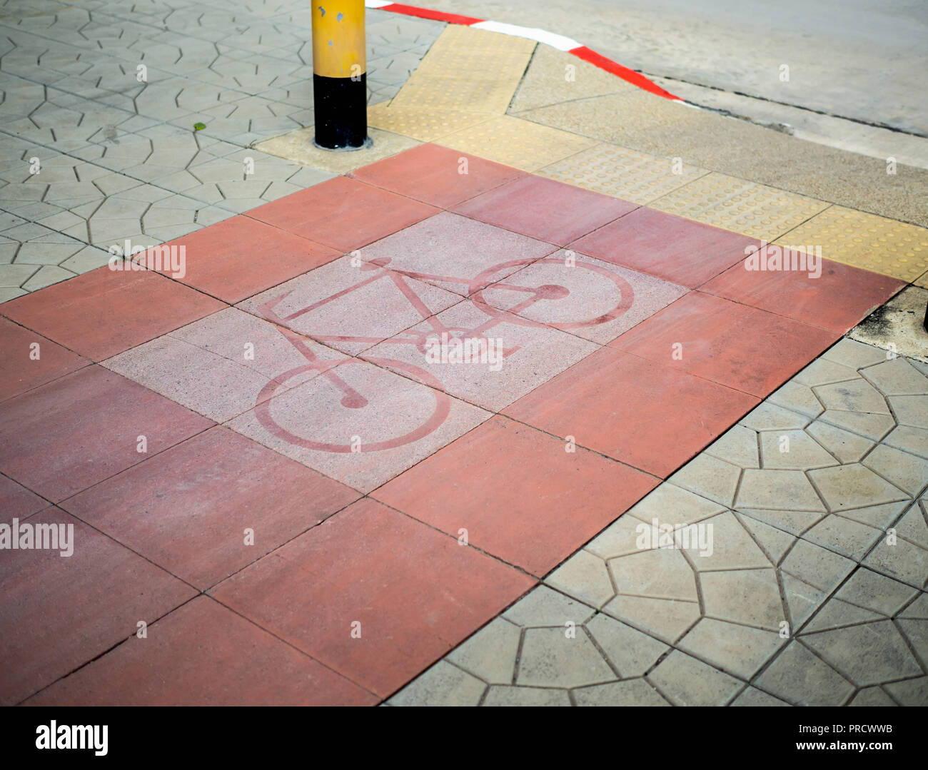 Bike lane sign on red floor. Bicycle symbol on red footpath near the ...