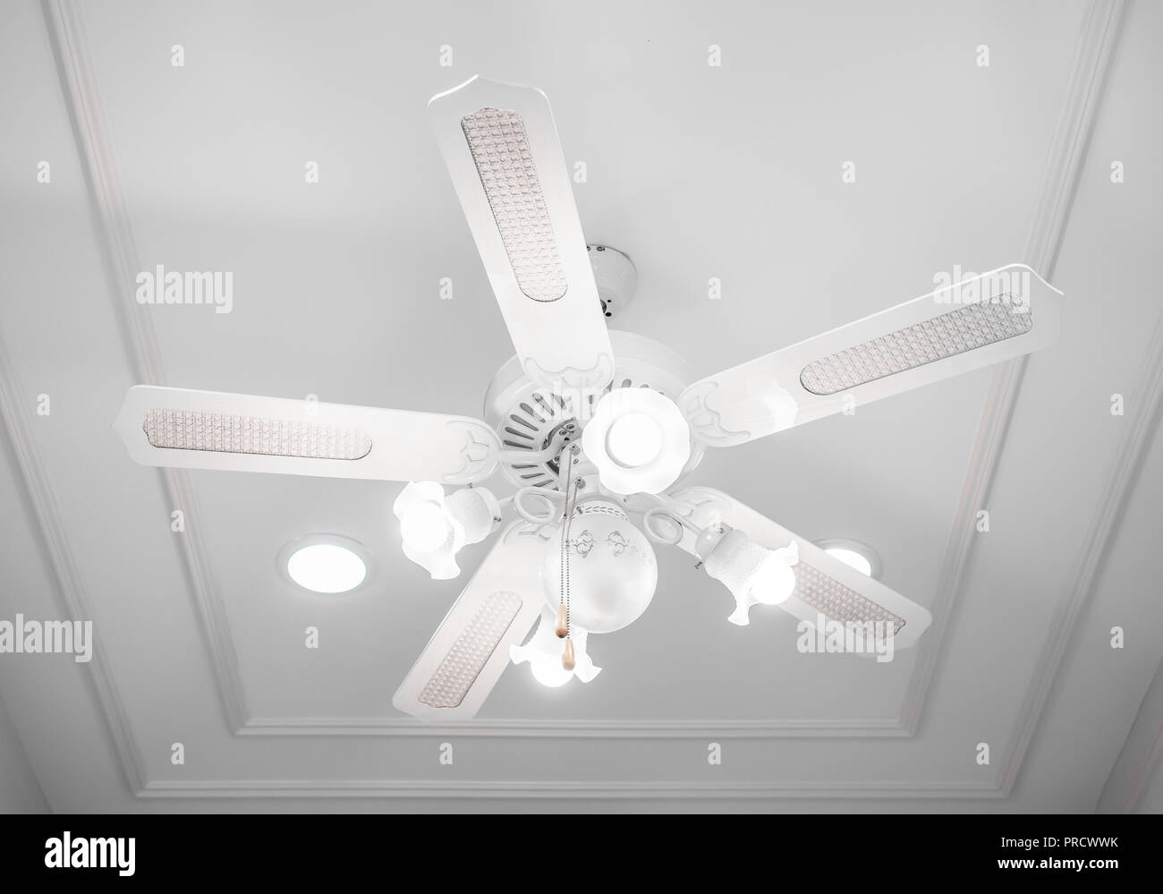 Vintage classic white ceiling fan with the light on white background ...