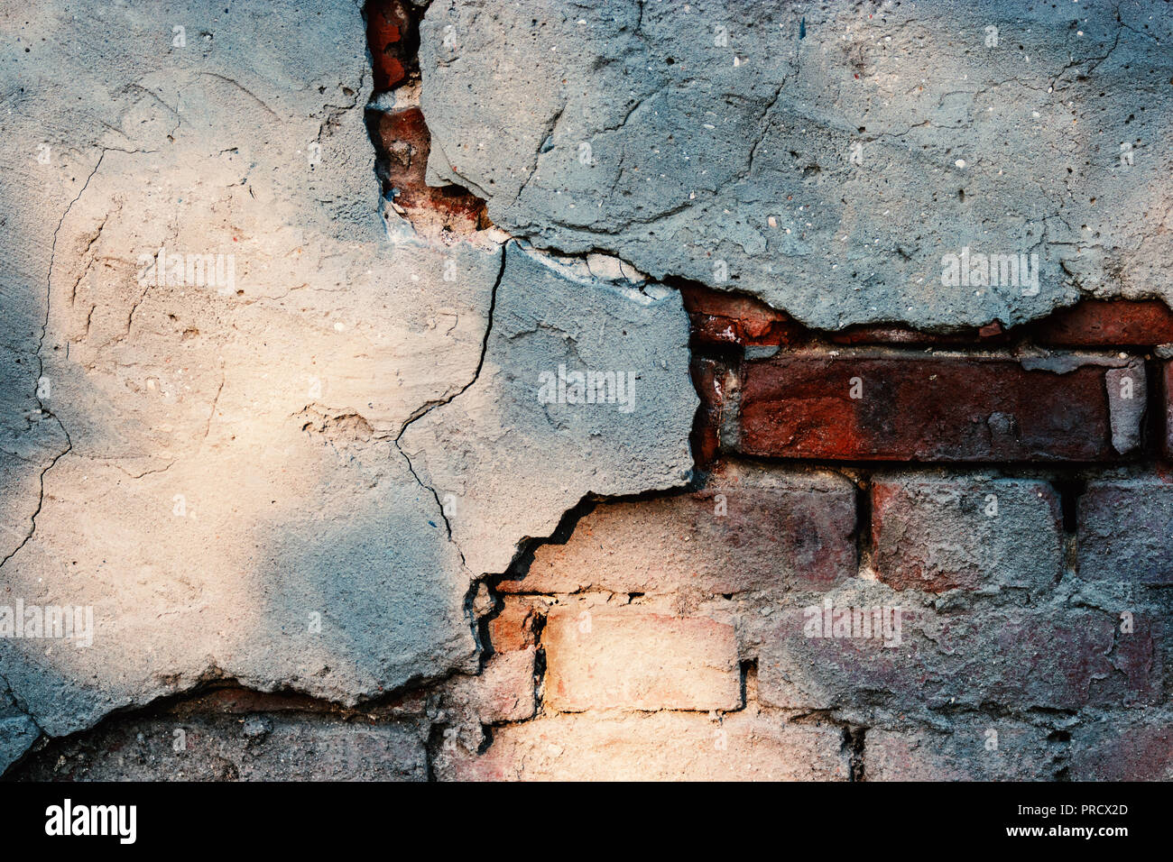 Brick wall with damaged plaster Stock Photo - Alamy