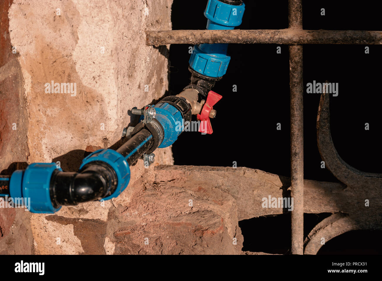 Plastic pipes with red valve Stock Photo - Alamy