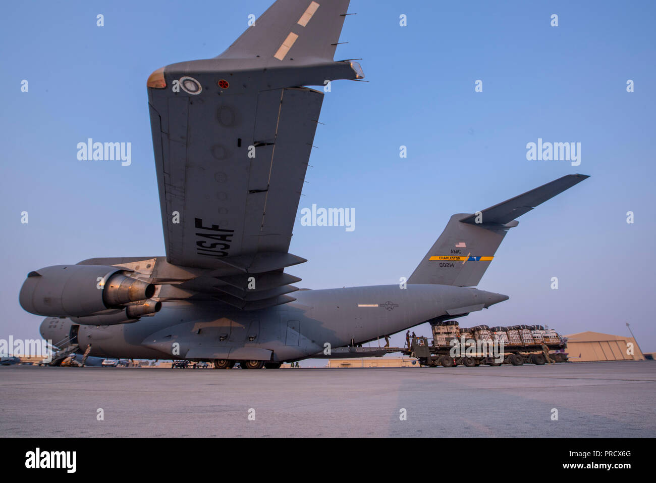 Airmen with the 8th Expeditionary Air Mobility Squadron use a K-loader ...