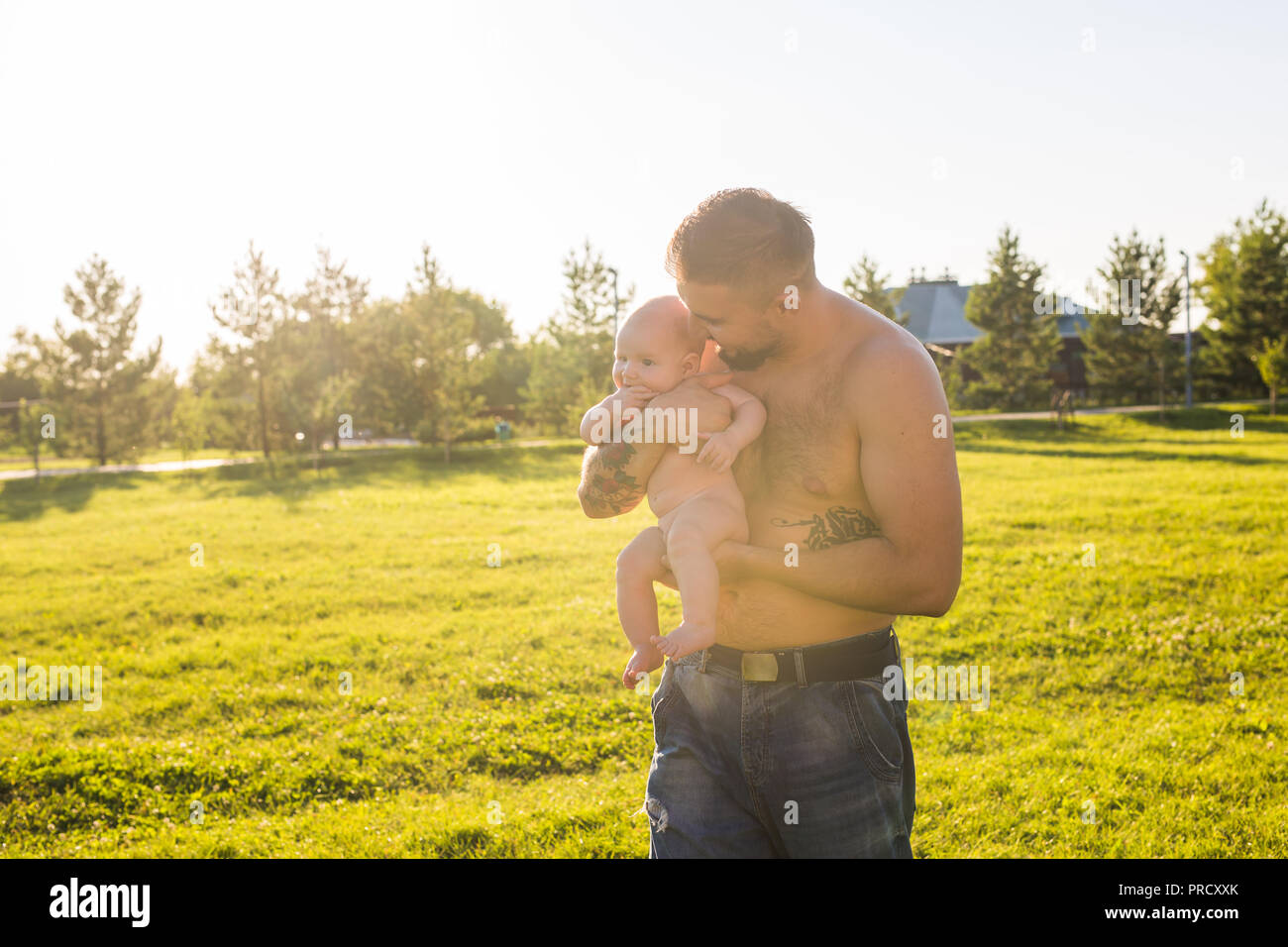 Happy father holding baby son on nature. Concept of happy family ...
