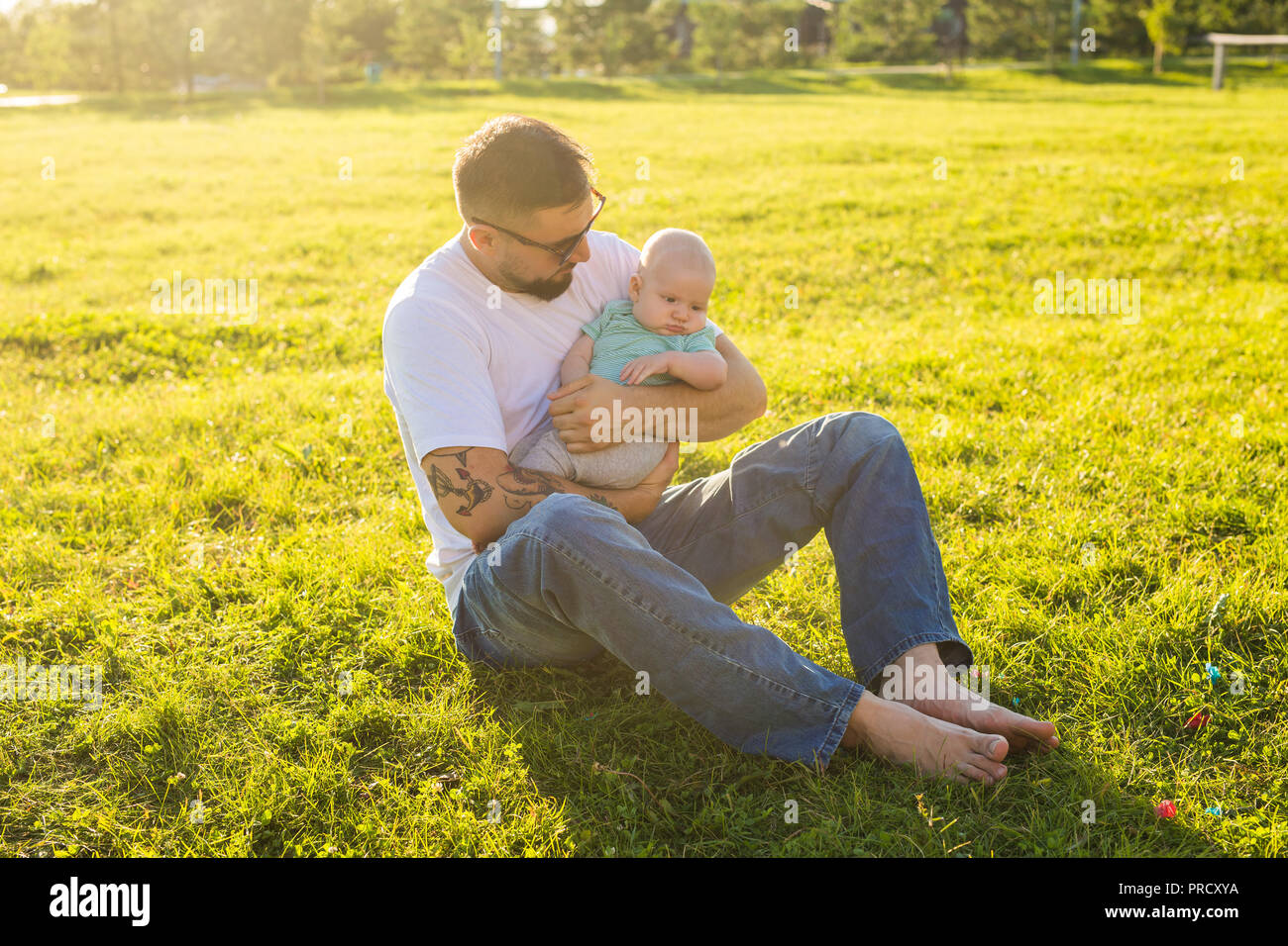 Happy father holding baby son on nature. Concept of happy family ...