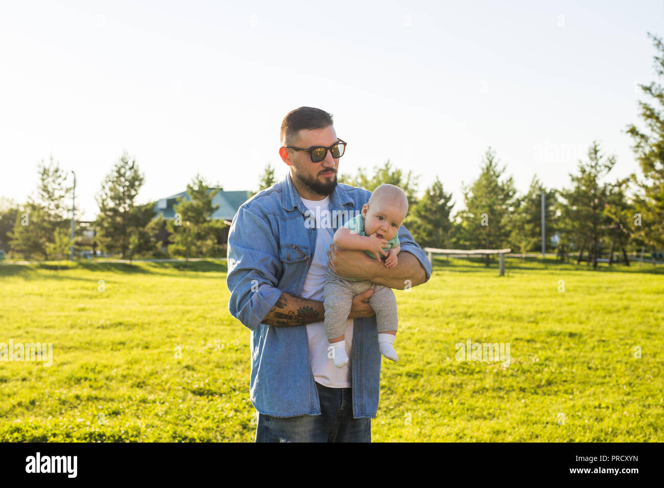 Happy father holding baby son on nature. Concept of happy family ...