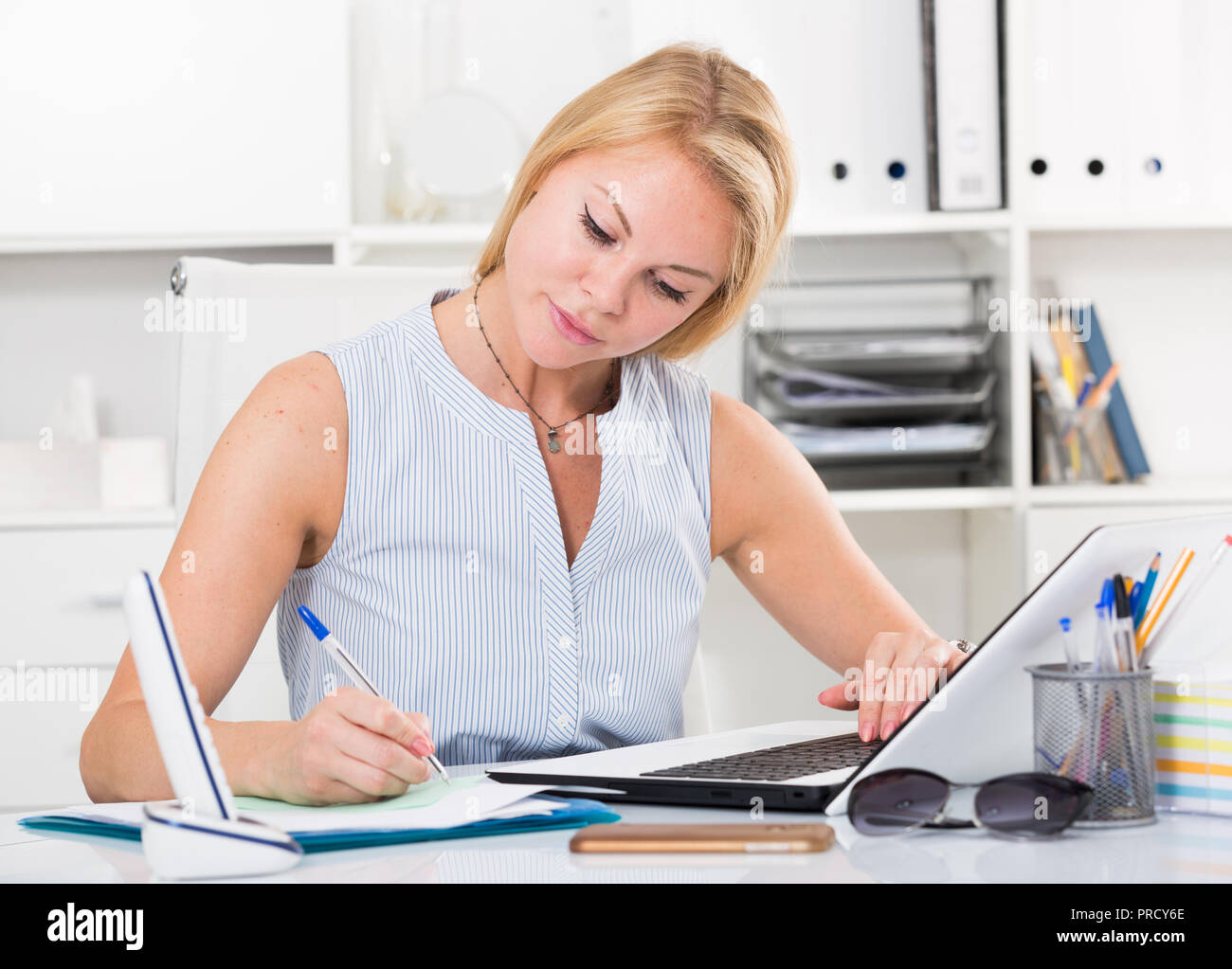 portrait of adult russian girl business manager writing and working ...