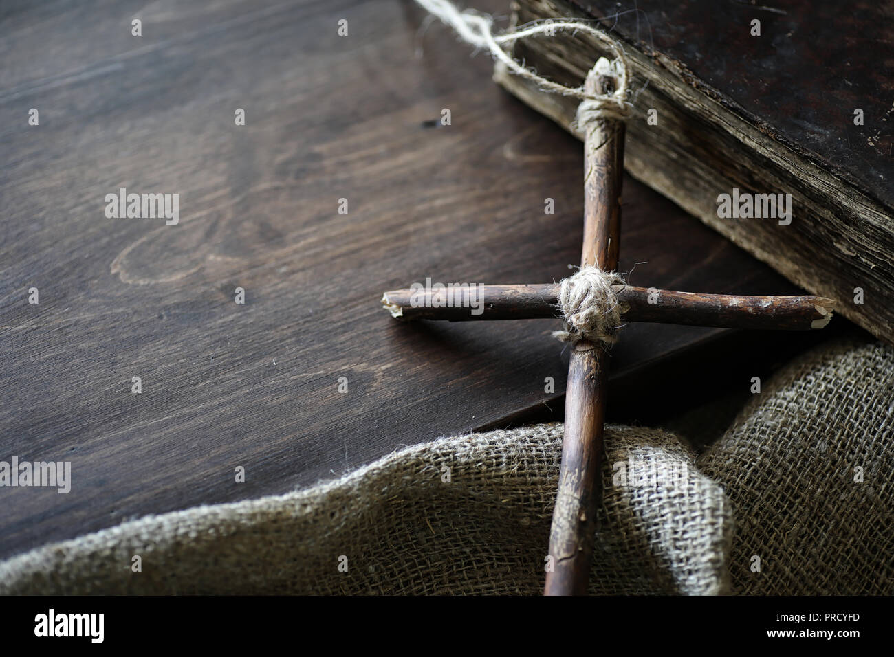 Ancient religious book and wooden cross on the background of a wooden ...
