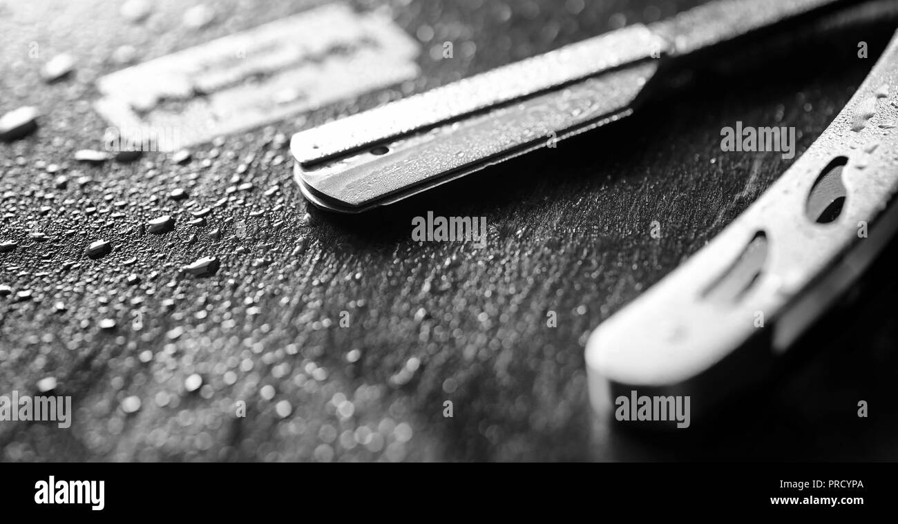 A dangerous razor and a metal blade on the table. Men's shaving ...