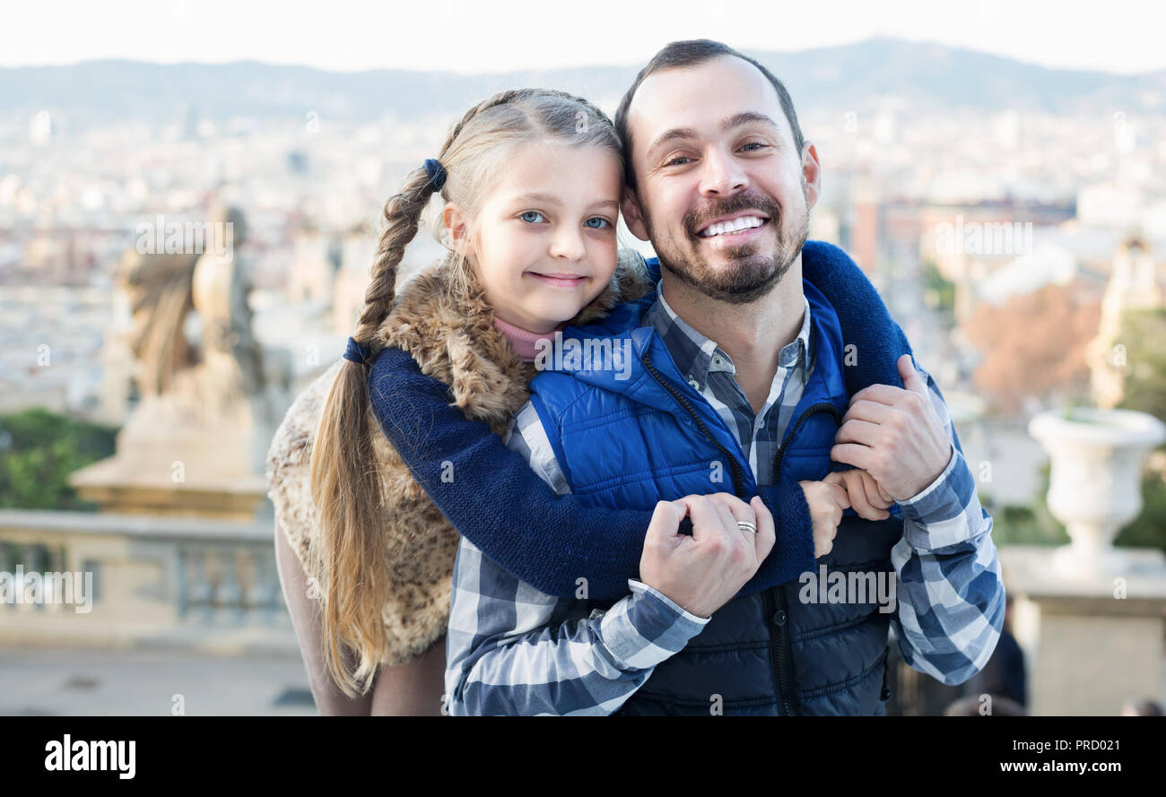 Smiling father and daughter enjoying city walk during sightseeing tour ...