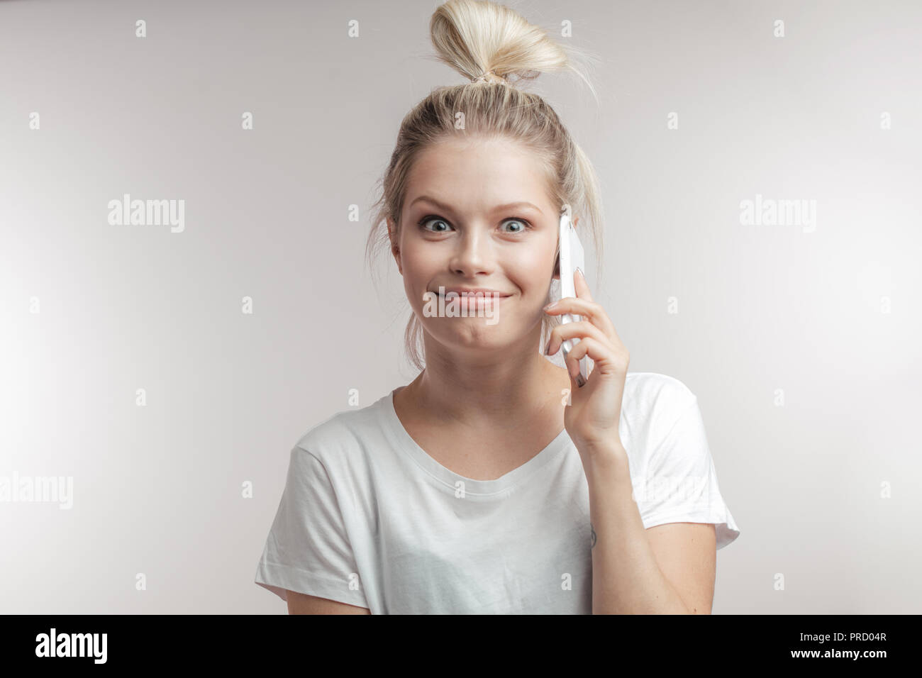 Confused puzzled woman holding her smart phone. Human emotions, body ...