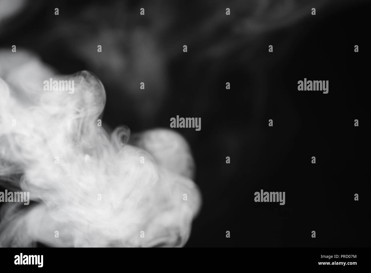 White smoke on a black background. Texture of smoke. Clubs of white ...