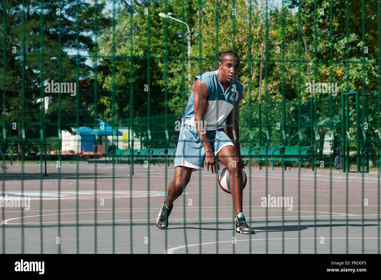 Picture of young confused african basketball player practicing outdoor ...