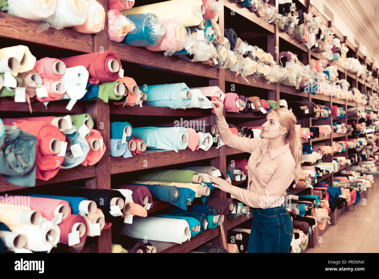 Blonde woman choosing textiles hi-res stock photography and images - Alamy