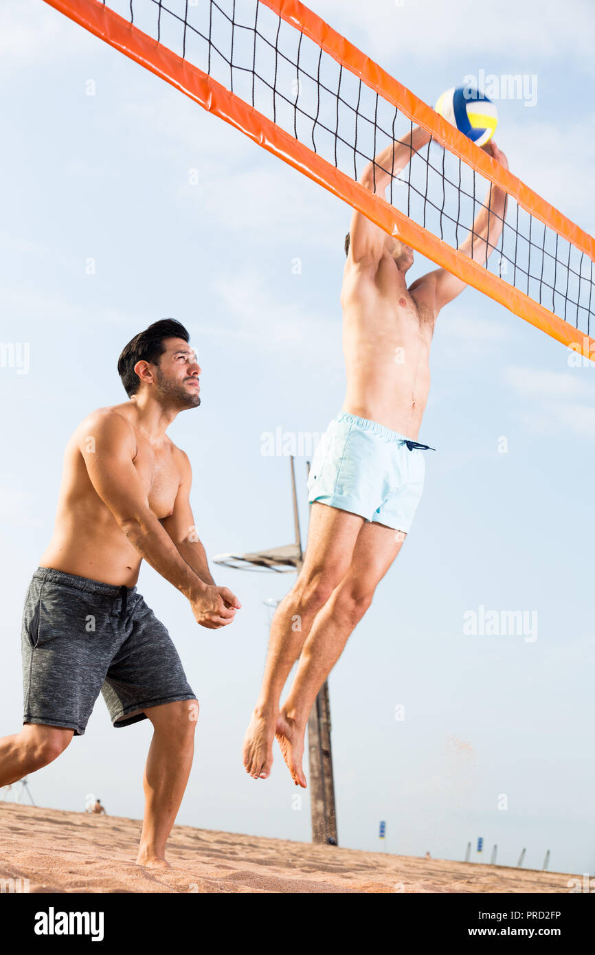 Two friends are playing in volleyball on the beach Stock Photo - Alamy