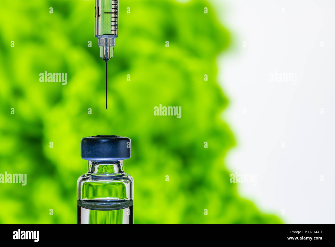A syringe with the needle point to the vaccine vial on the colorful ...