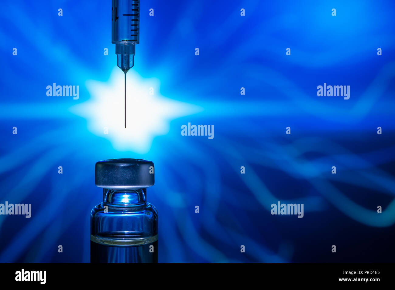 A syringe with the needle point to the vaccine vial on the colorful ...