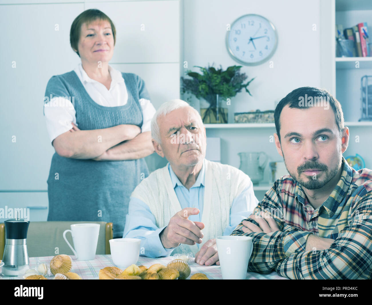 Elderly grandfather teaches his grandson in presence of grandmother ...