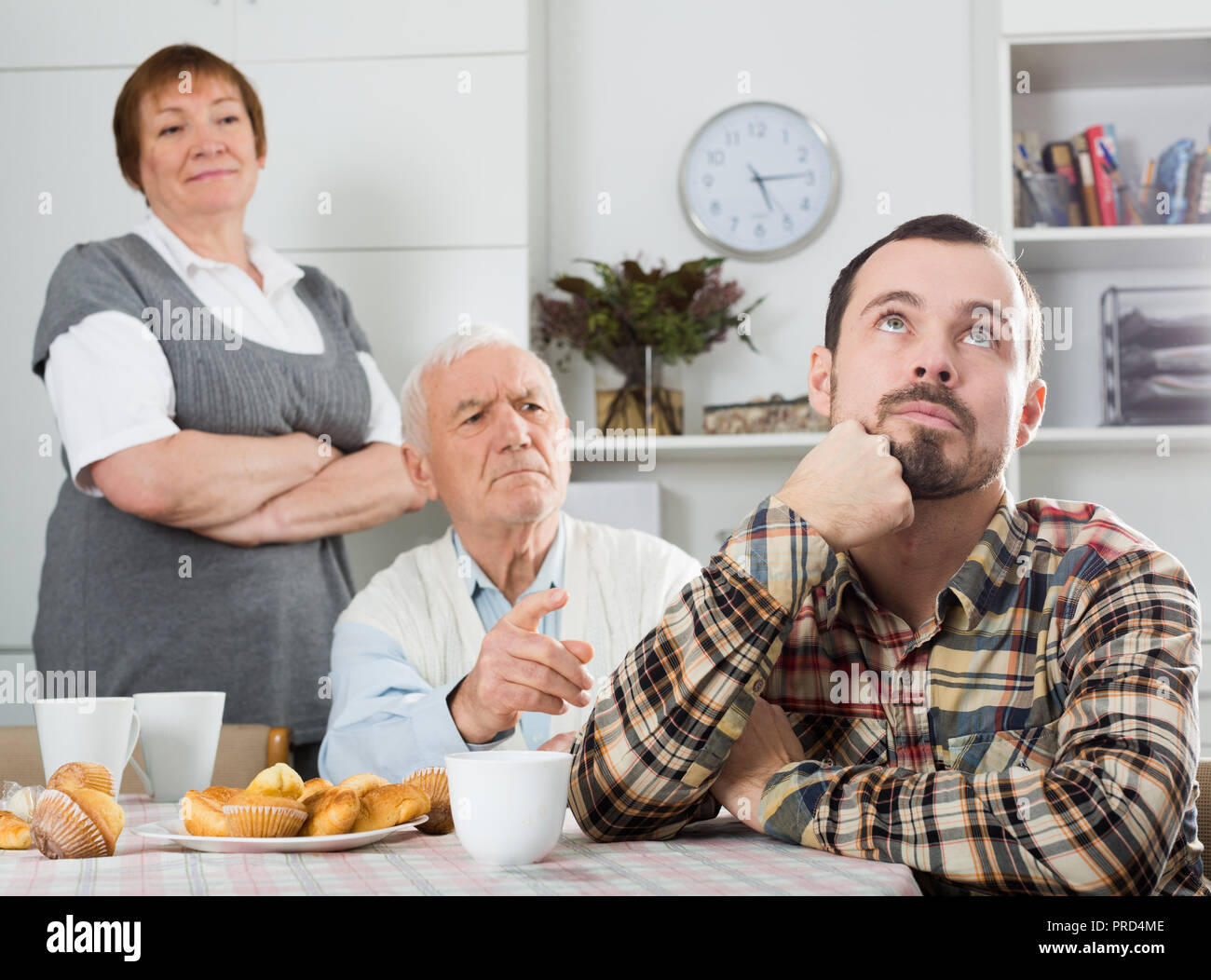 Elderly grandfather teaches his grandson in presence of grandmother ...