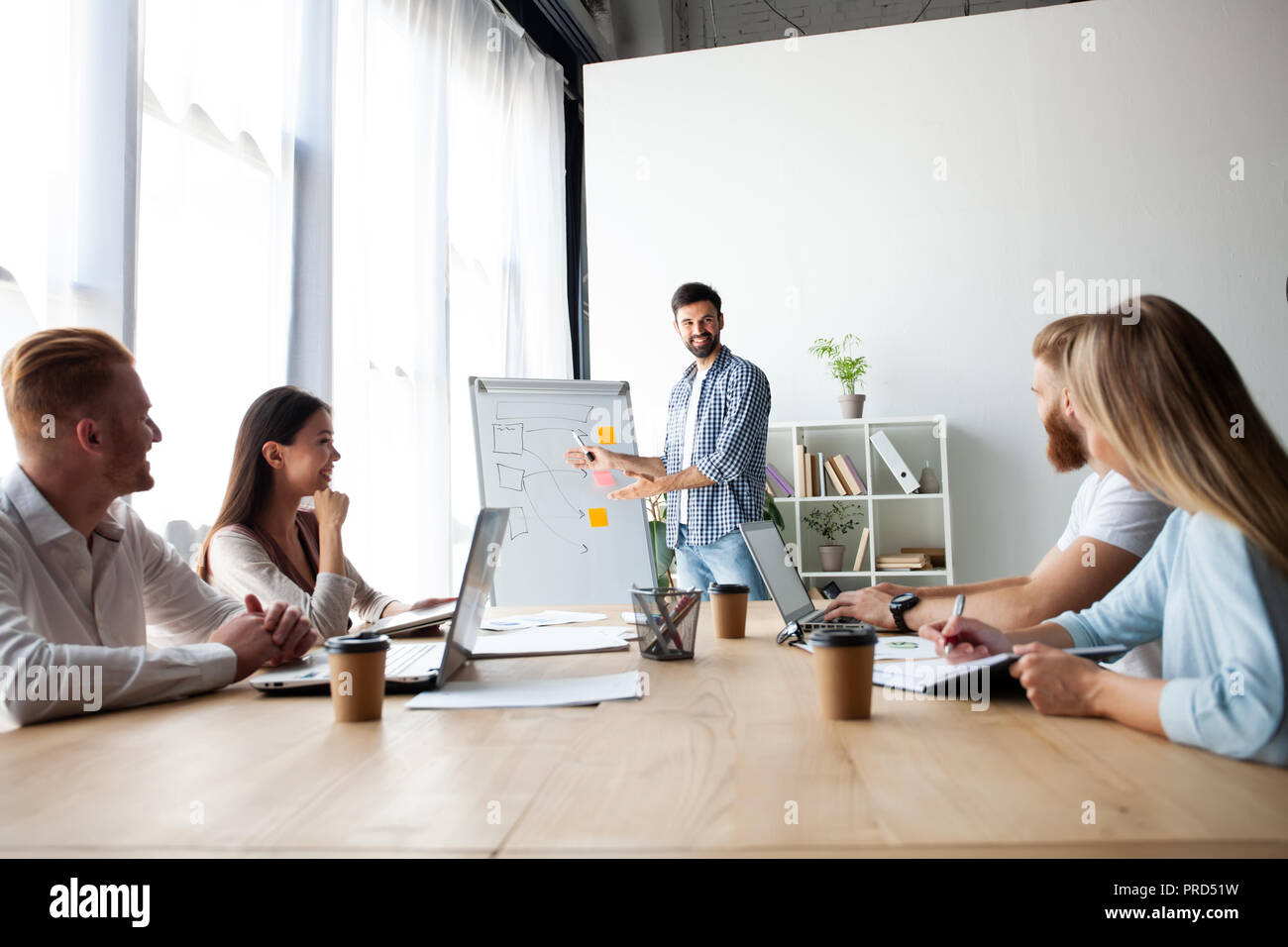 Achieving best results together. Modern young man conducting a business ...