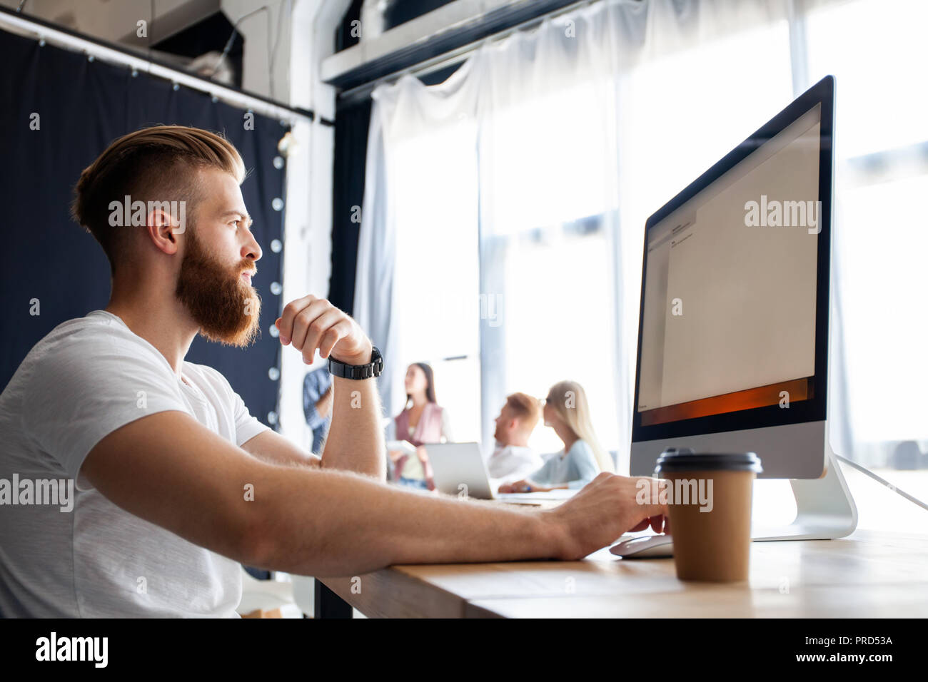 Creative office. Young modern colleagues in smart casual wear working ...