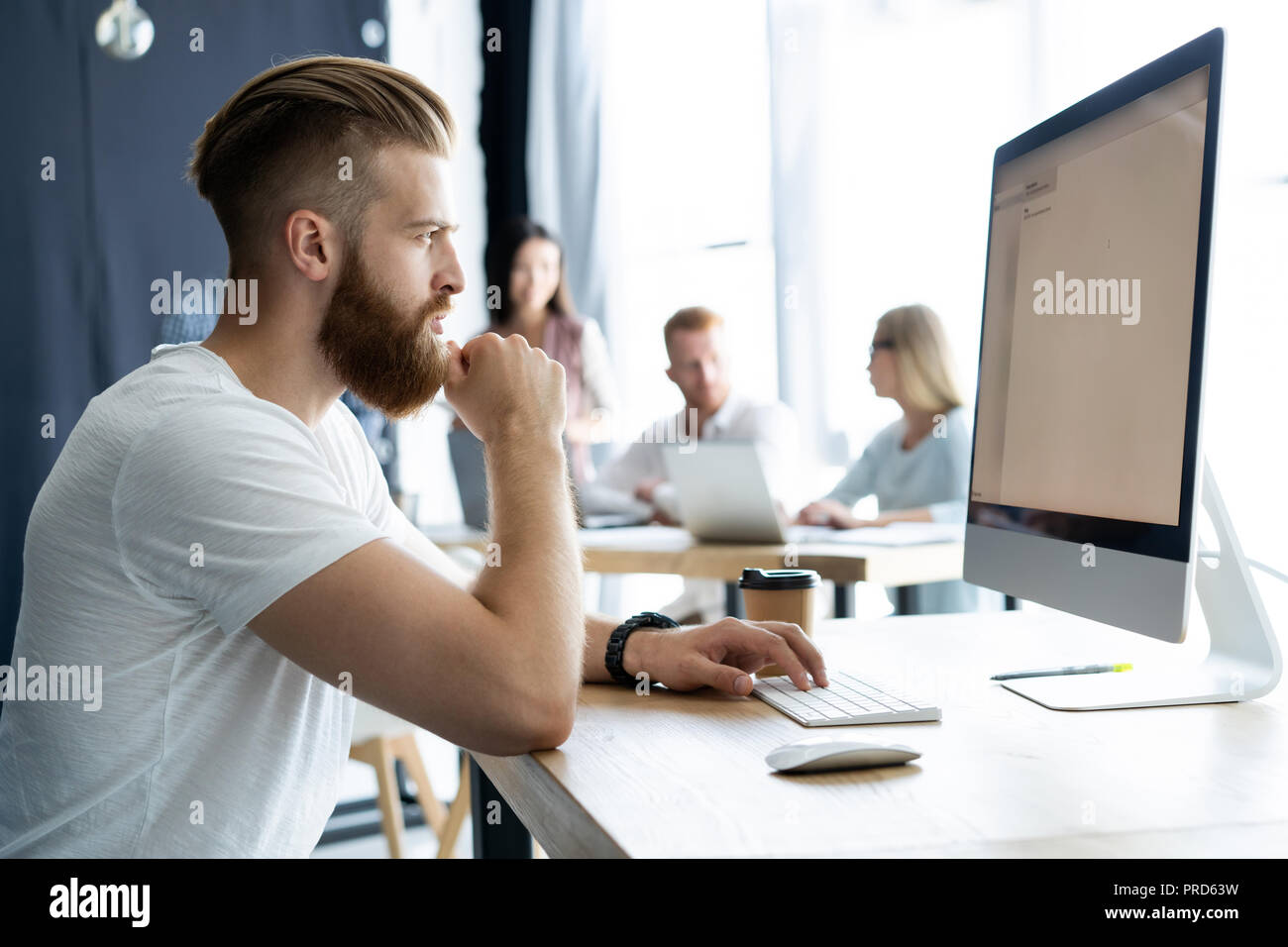 Creative office. Young modern colleagues in smart casual wear working ...