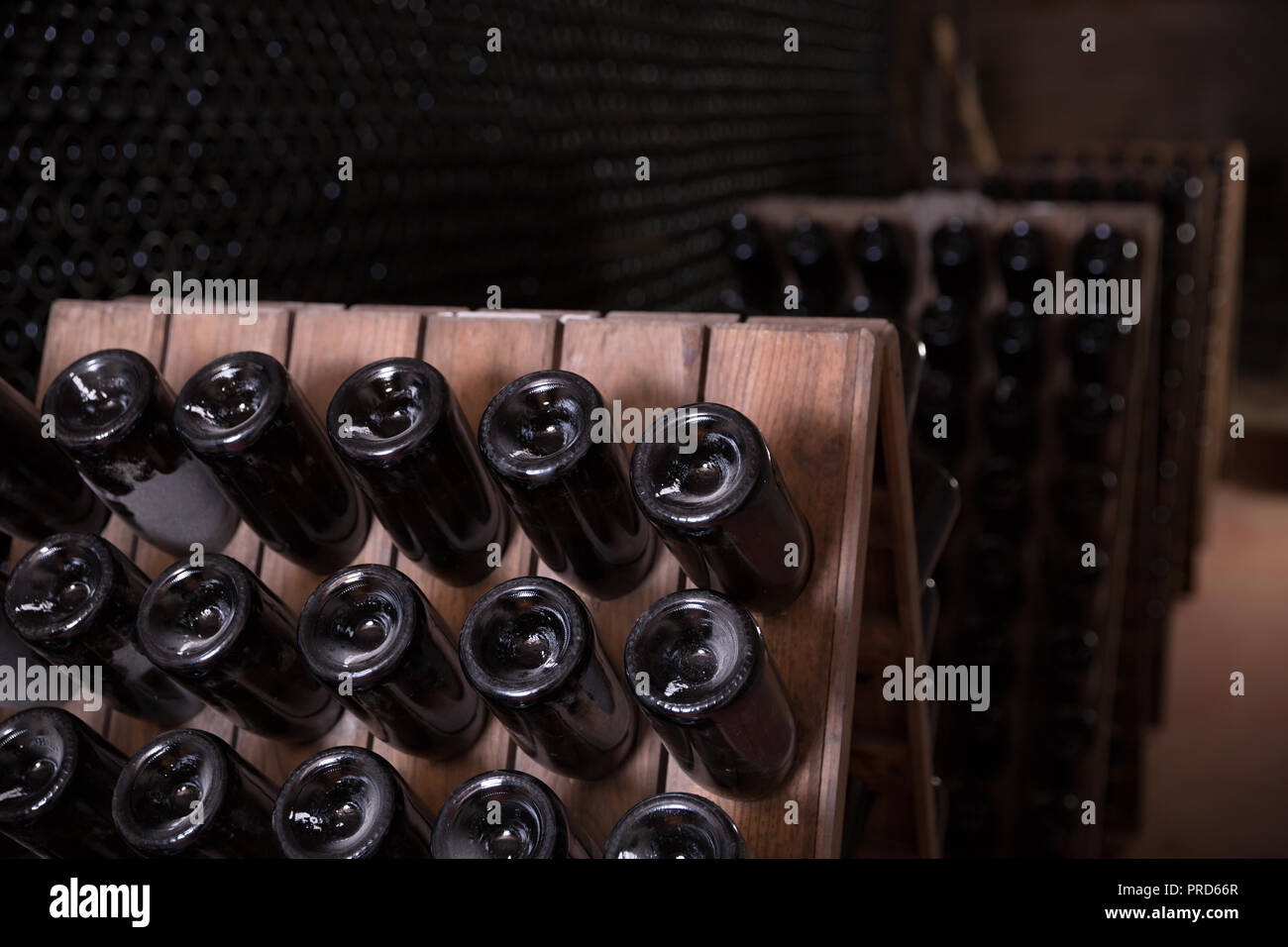 Process of wine maturation in bottles on wooden racks in wine vault ...