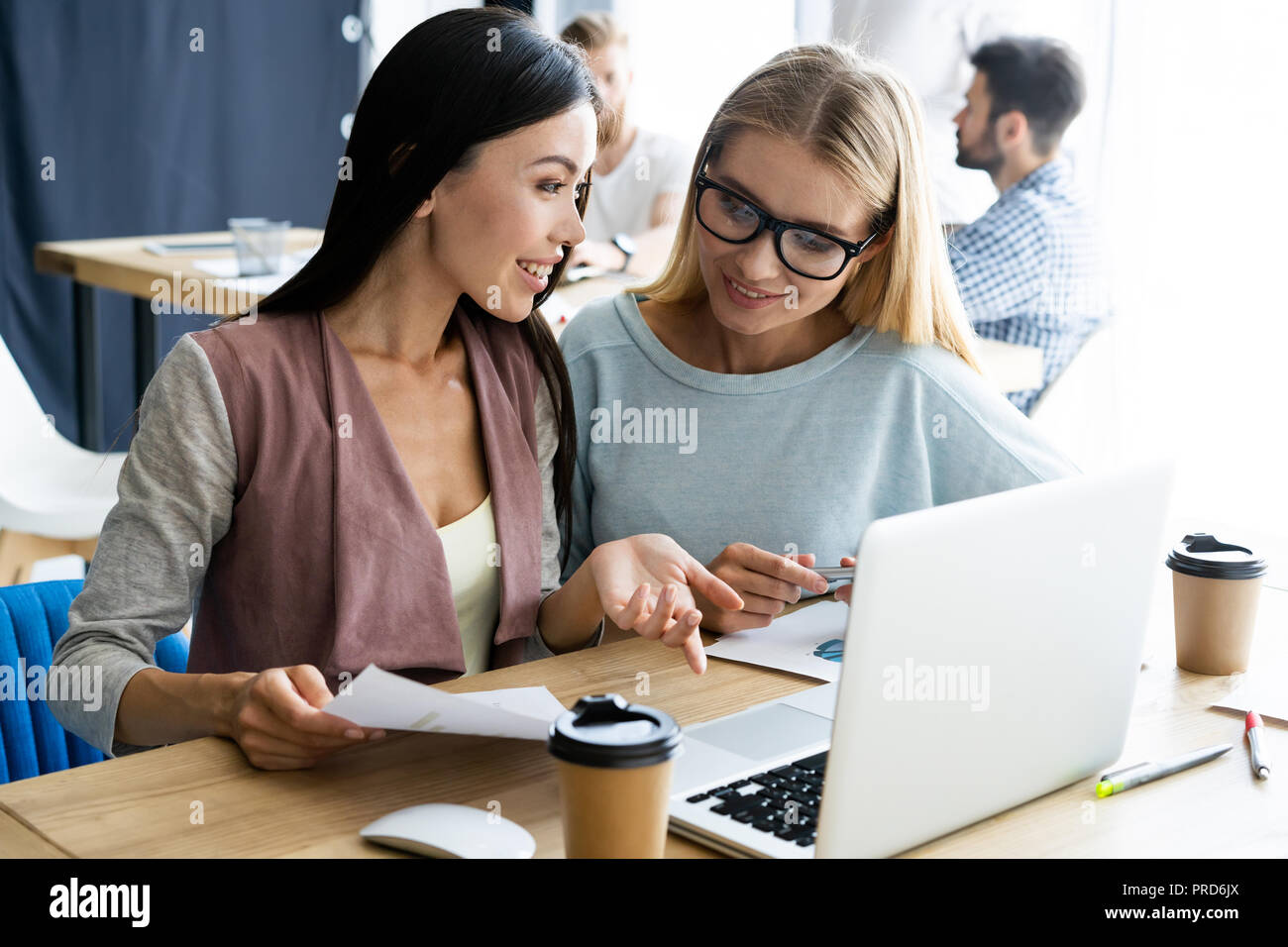 Two female colleagues in office working together Stock Photo - Alamy