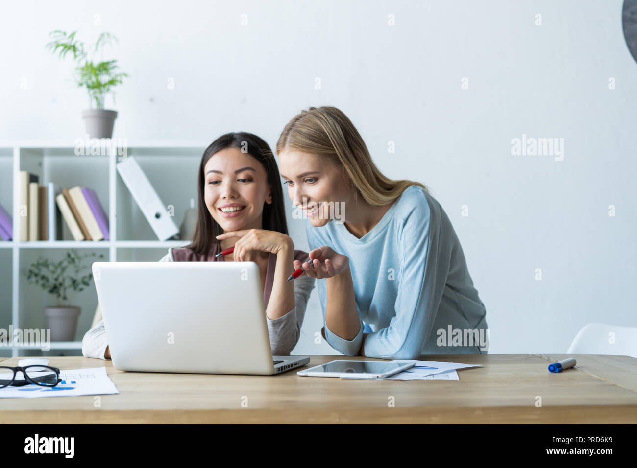 Two female colleagues in office working together Stock Photo - Alamy