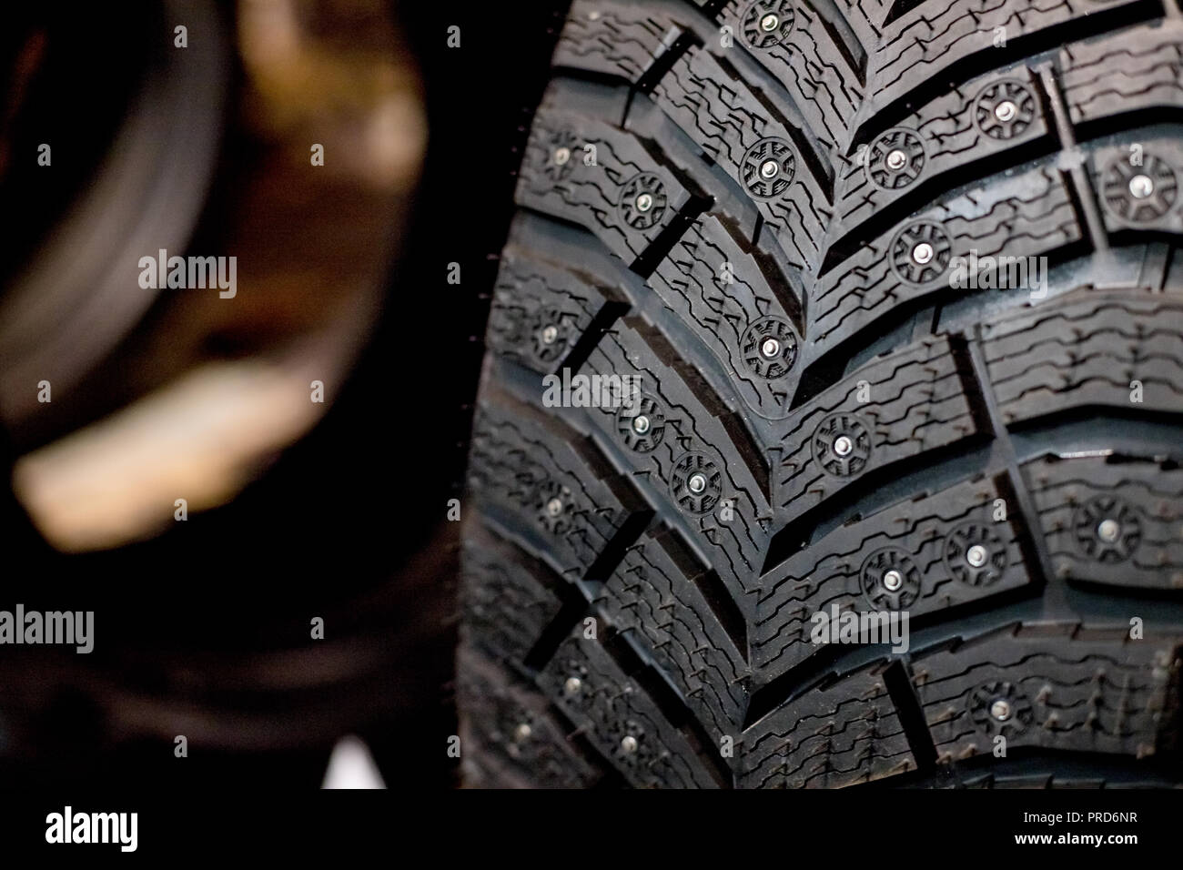 Winter Car tires with snow close-up wheel profile structure on black background.Car tires mature ...