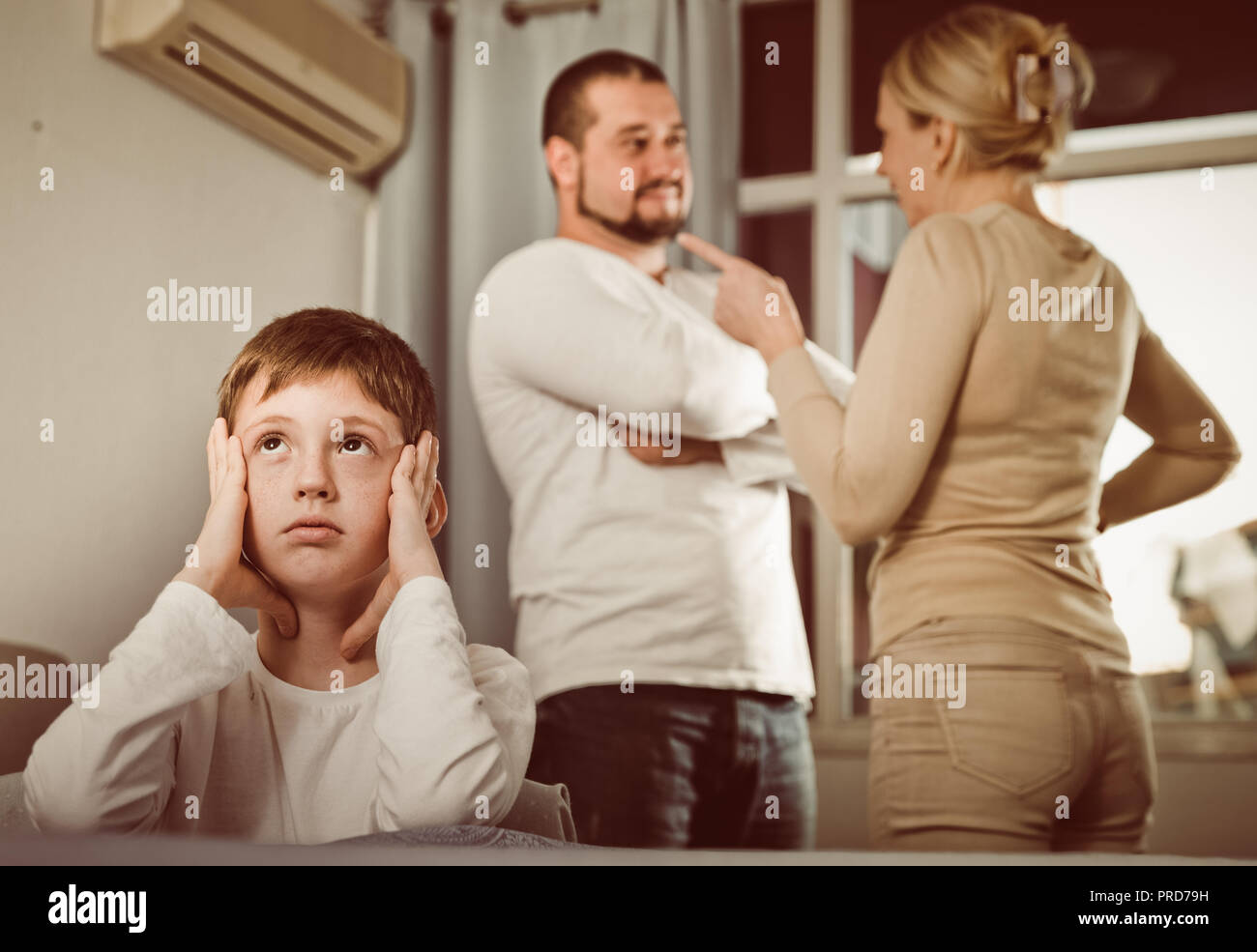 Sad desperate little boy during parents quarrel in home interior Stock ...