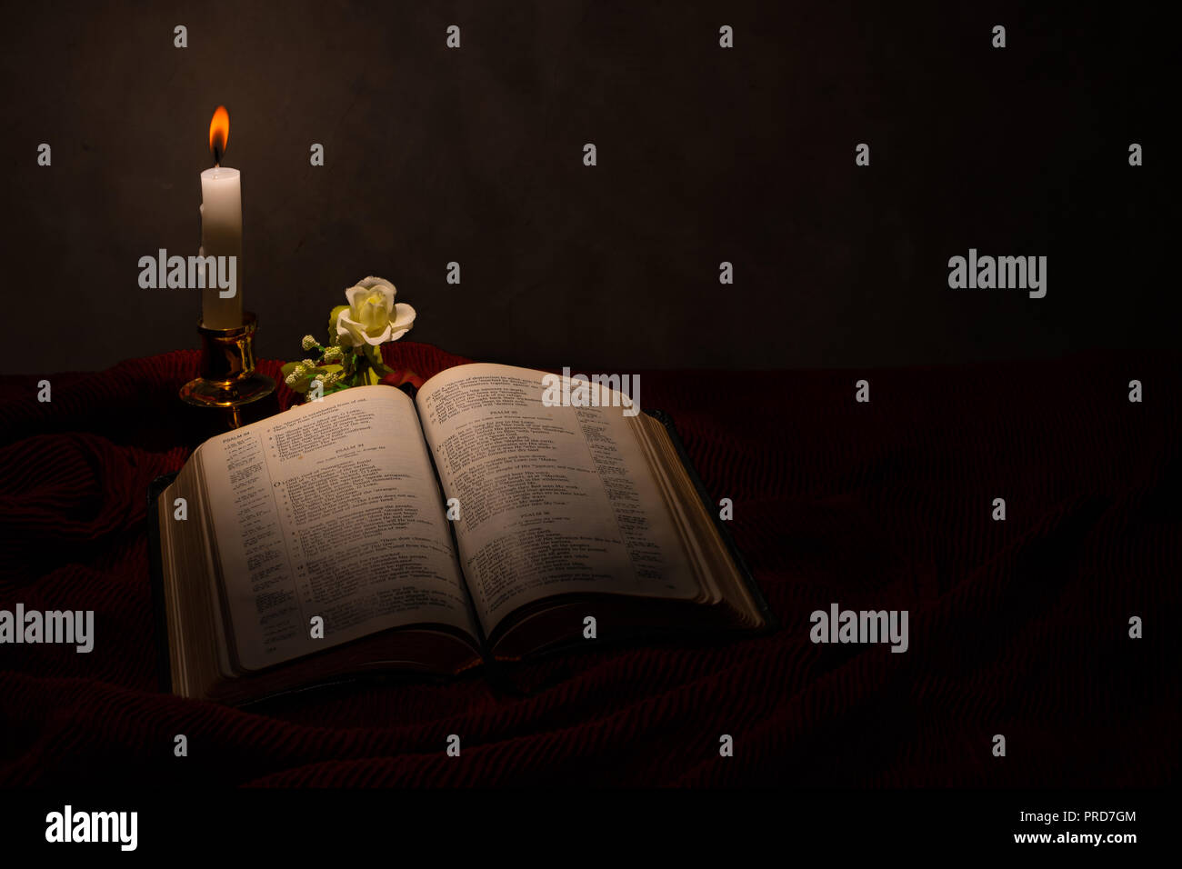 Reading the bible under the candle light on the candlestick Stock Photo ...