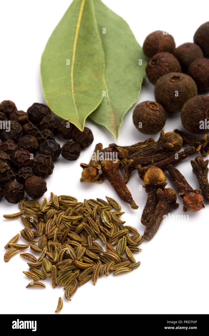 spices: bay leaves, cloves, cumin and pepper closeup on white ...