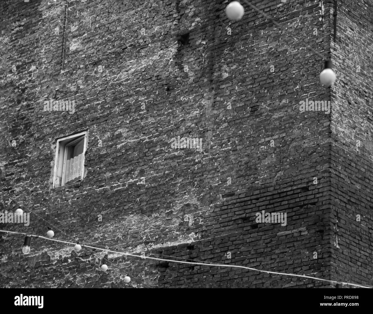 The desolate lonely old window at the corner of the house in black and ...