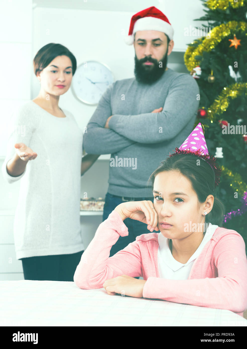 Young father and mother correcting their child for disobedience at ...