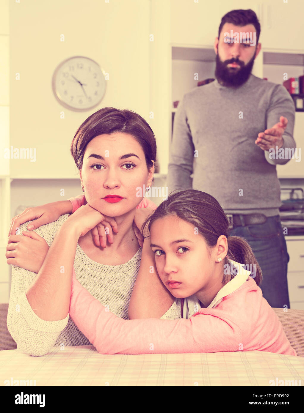 Young father correcting his wife and child for disobedience at home ...
